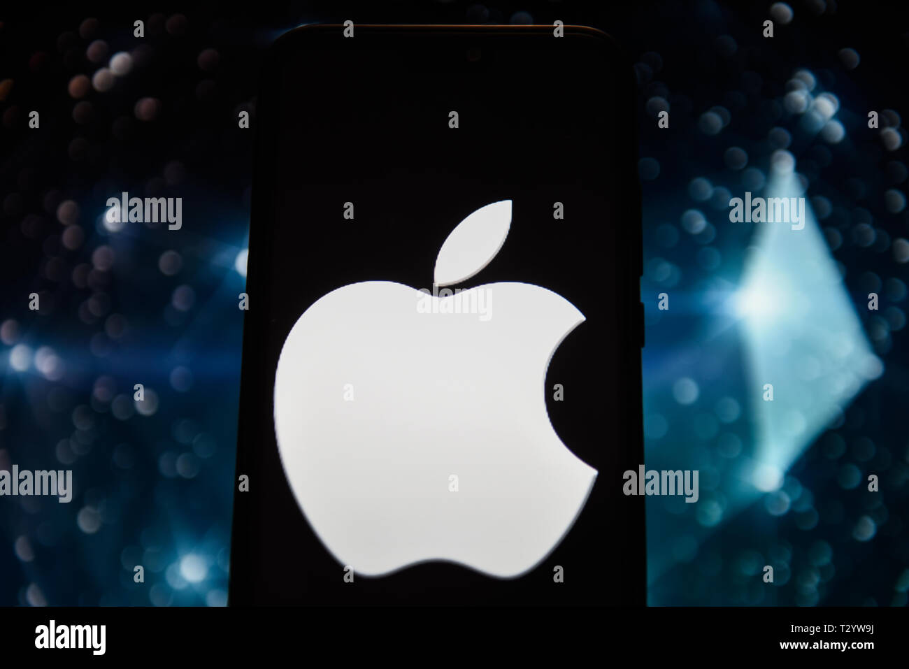 In this photo illustration an Apple logo seen displayed on a smart ...
