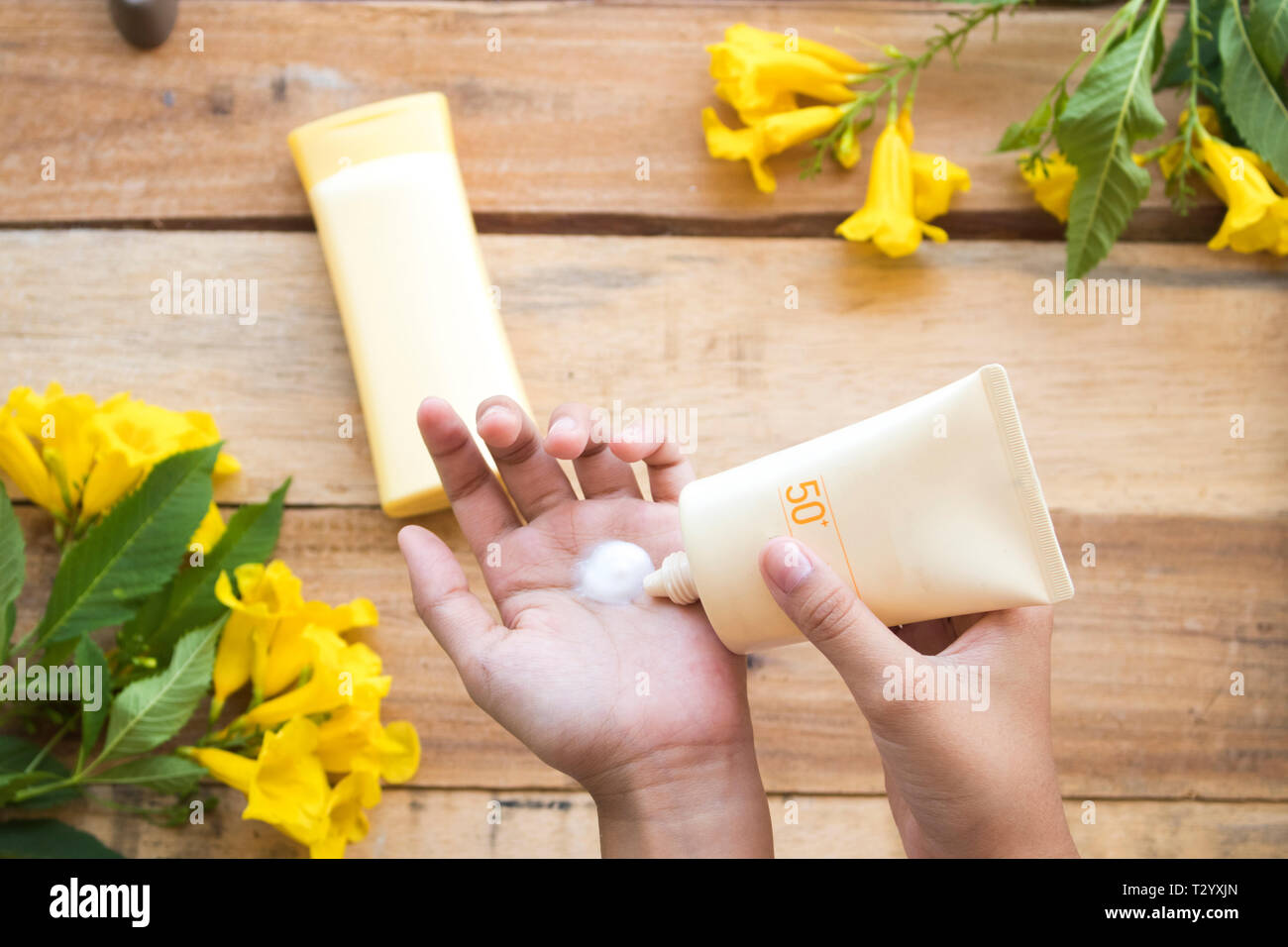 hand of girl slope cream cosmetics for skin face sunscreen ,body lotion ...