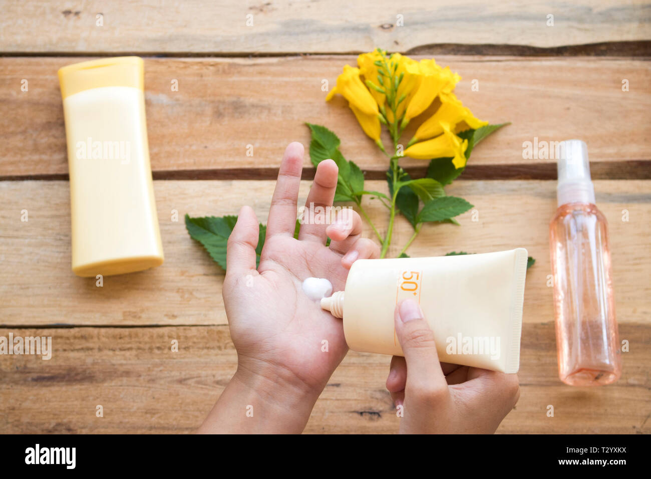 hand of girl slope cream cosmetics for skin face sunscreen ,body lotion ...