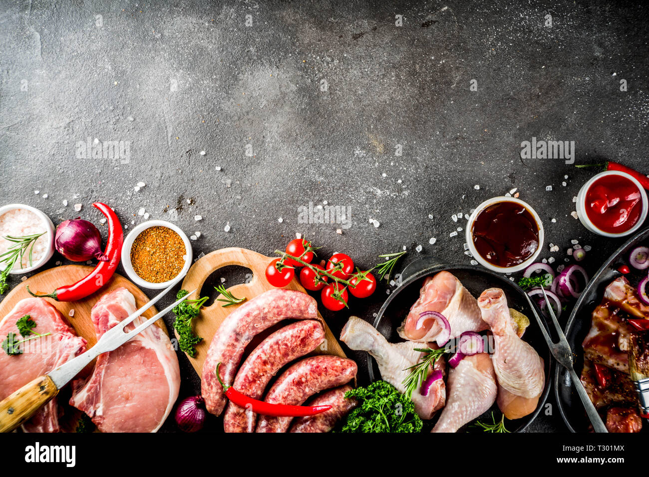Various raw meat ready for grill and bbq, with vegetables, greens ...