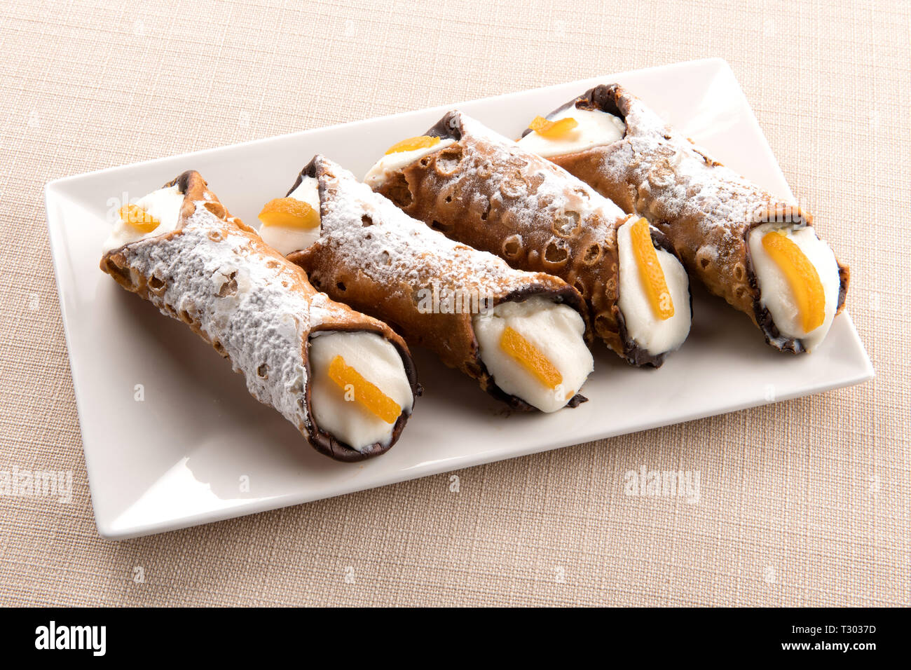 Four deep fried cannoli Sicilia pastries with creamy ricotta filling ...