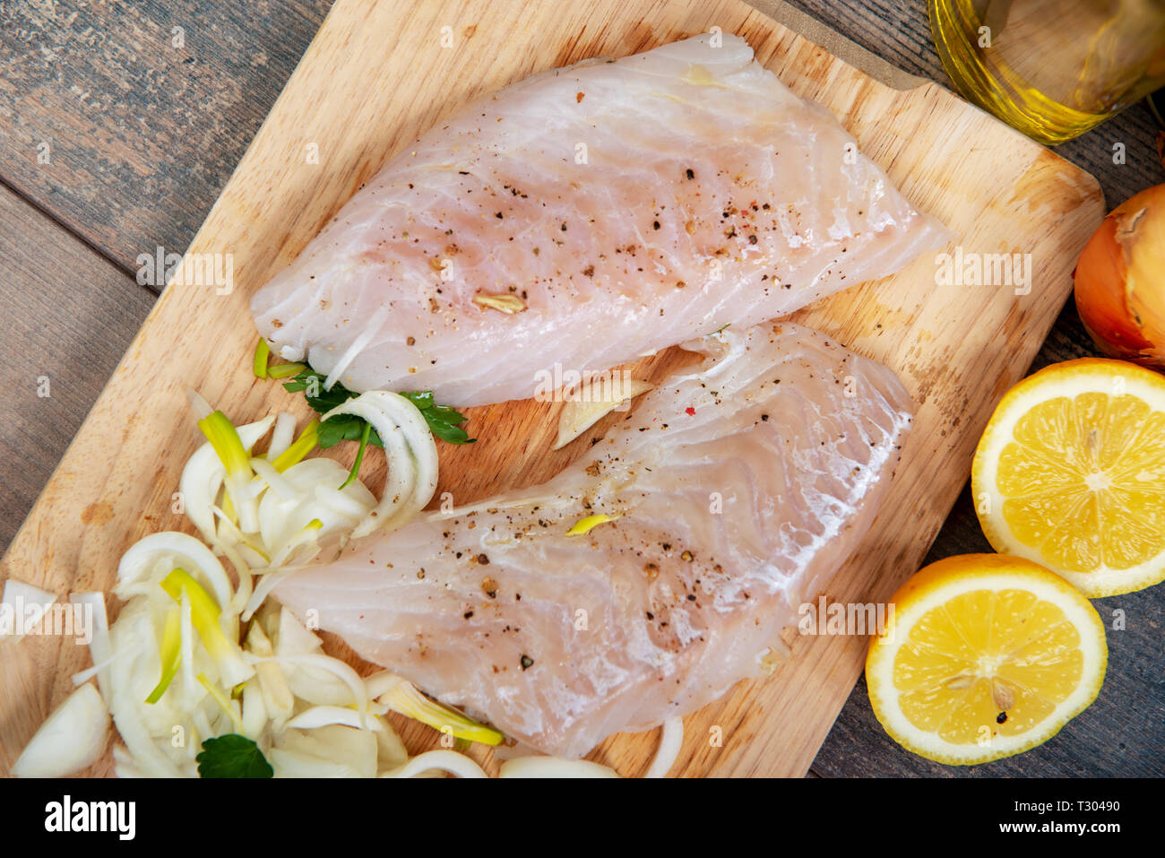 Fresh fish, a raw cod fillets with addition of herbs and lemon Stock ...