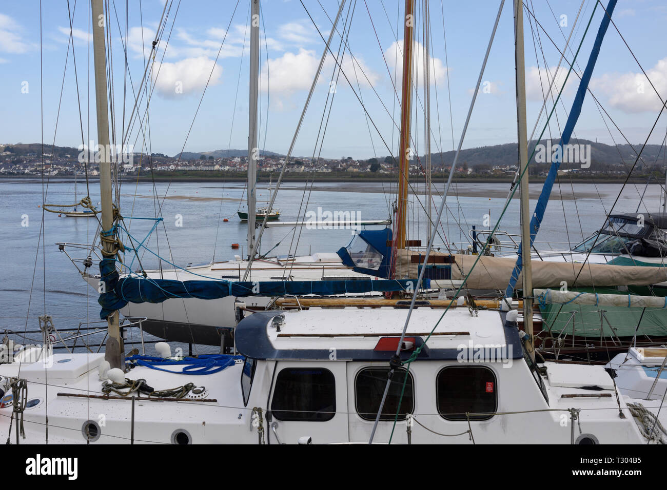 Fibreglass boats stored onshore, boats on quayside in Conwy harbour ...