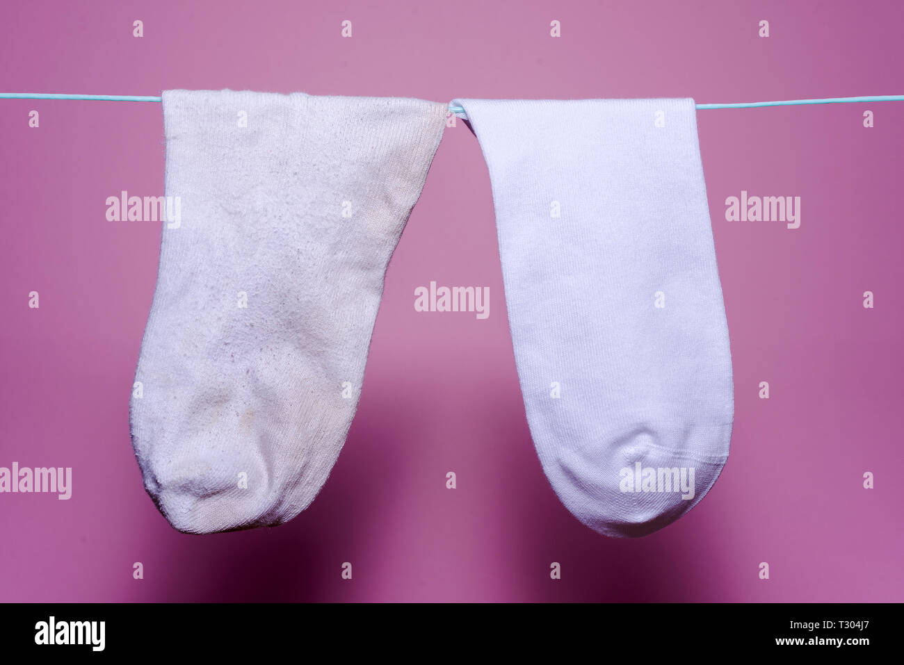 clean new white sock and next to the dirty old sock weighs. concept ...