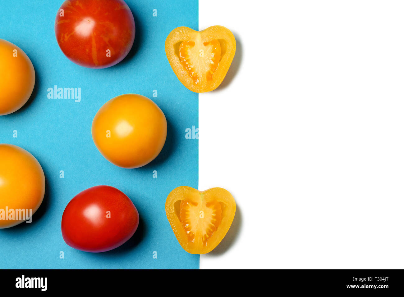 cut and group of heart shaped tomato. blue white background. copy space ...