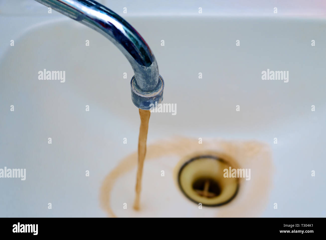 Dirty rusty water is pouring from the tap. concept of ecology Stock ...