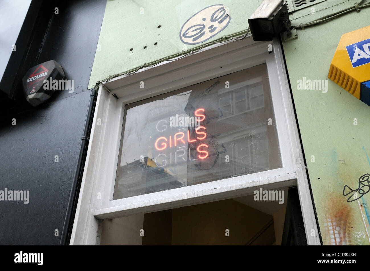 GIRLS neon sign above a doorway entrance to a walk-up in the Red Light ...