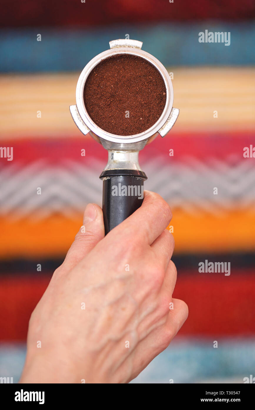 Portafilter containing freshly ground coffee Stock Photo - Alamy