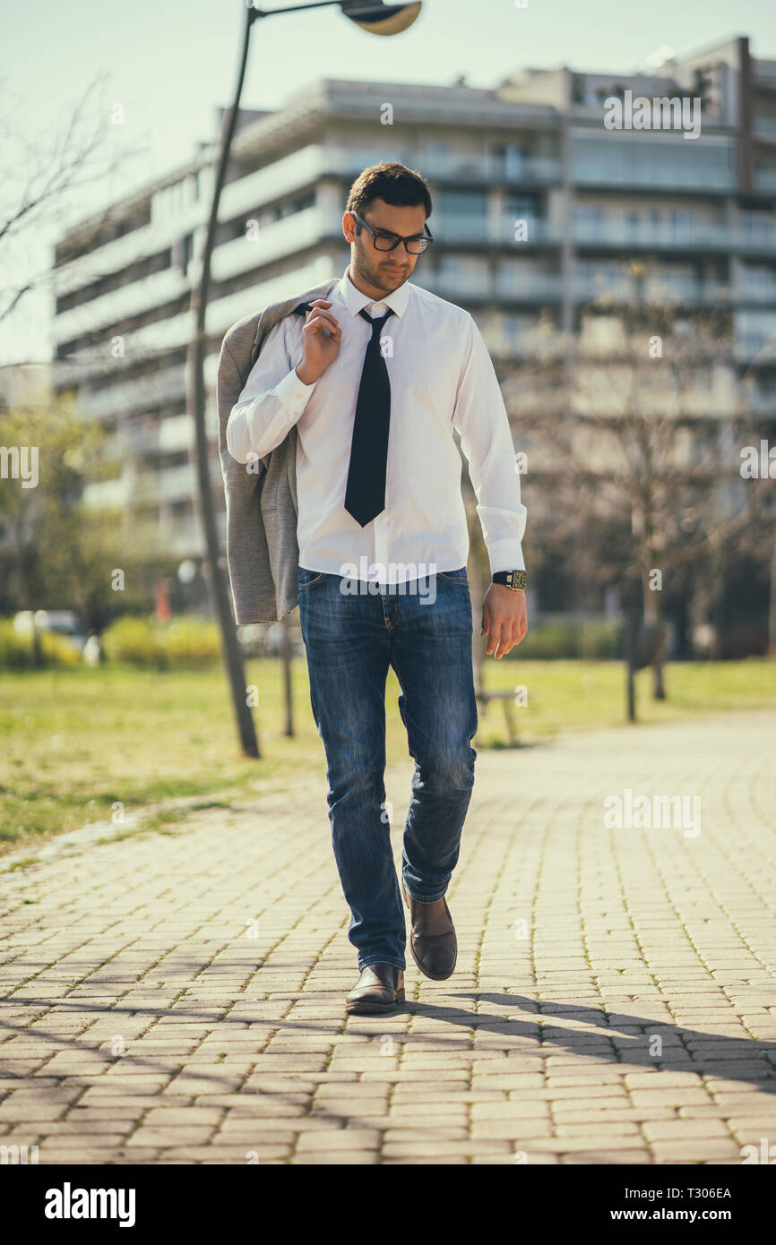 Young tired businessman is going home from work Stock Photo - Alamy