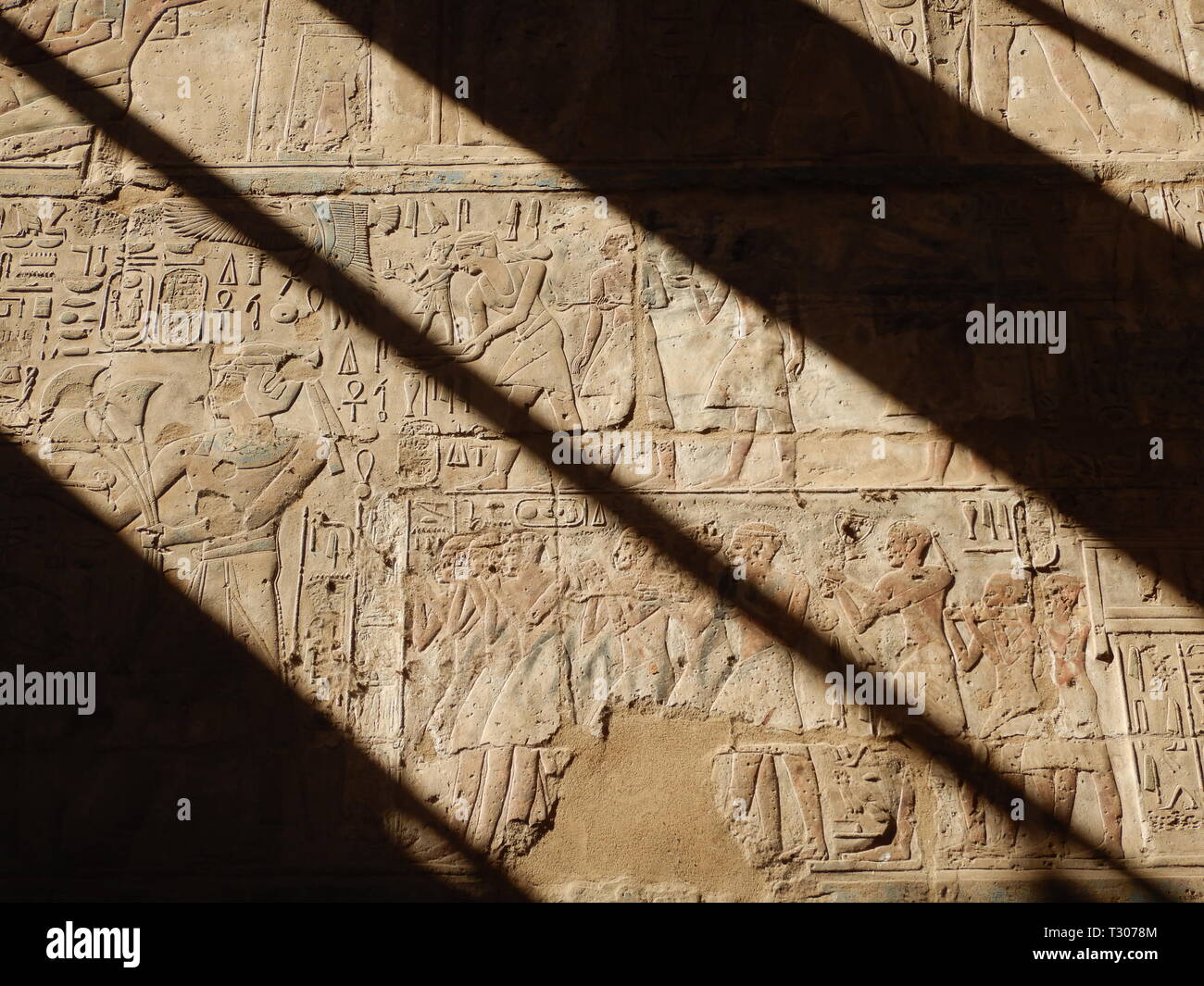 Hieroglyphs in ancient egypt masked in light shadow Stock Photo - Alamy