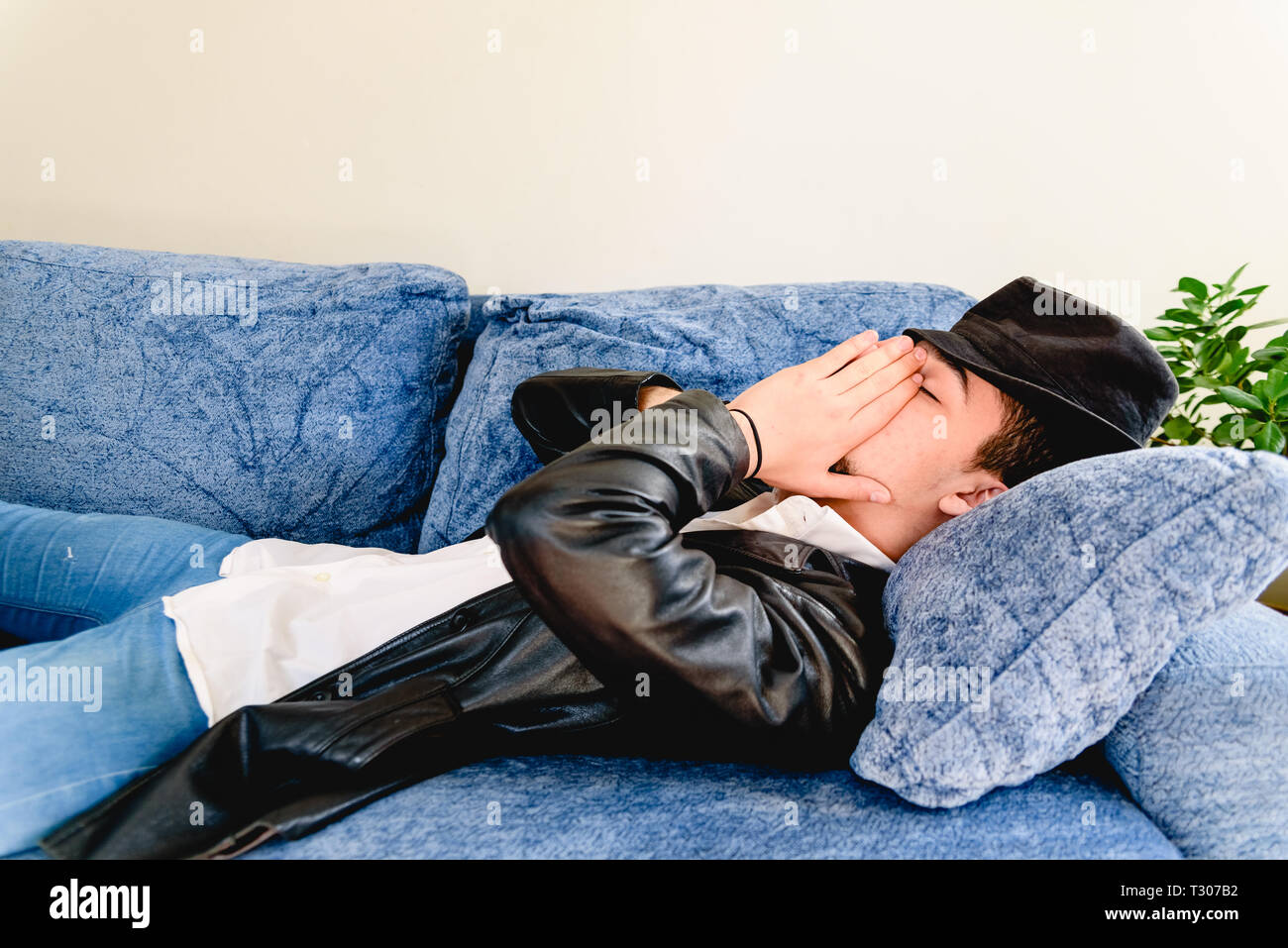 Tired businessman lying on sofa hi-res stock photography and images - Alamy