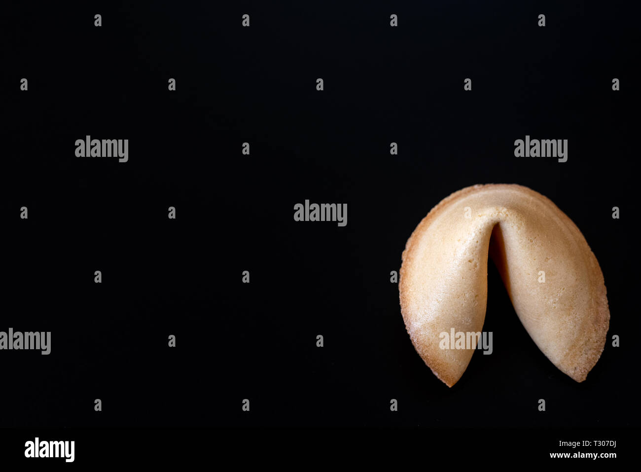 Fortune cookie on black background Stock Photo - Alamy