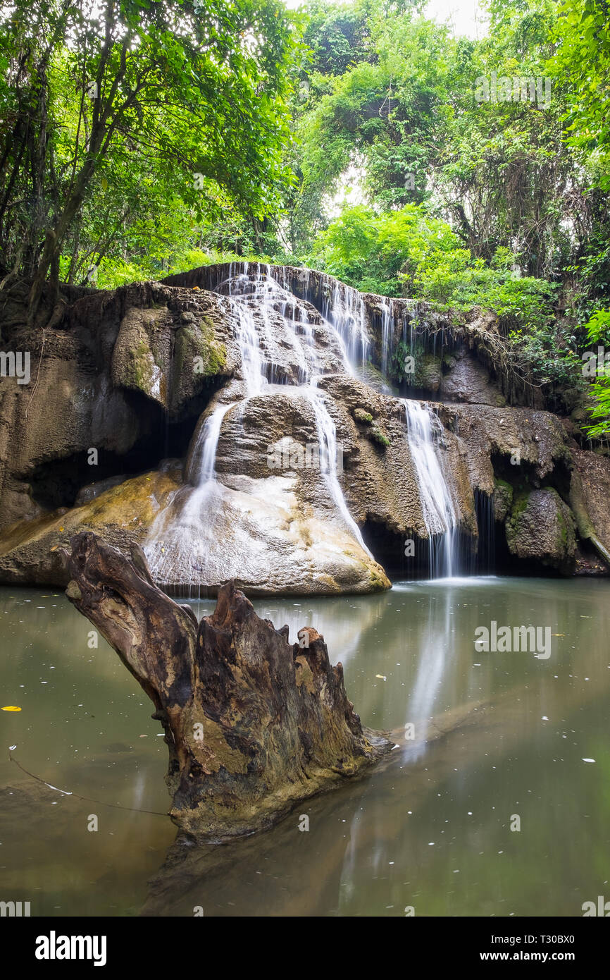 Waterfall cliff with log in rainforest at huai mae khamin national park ...