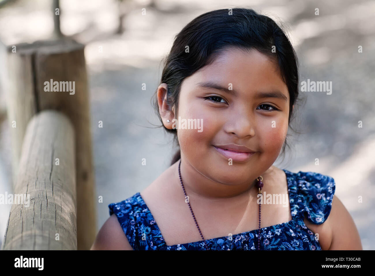 Portrait of a pretty young girl wearing a blue country western style ...