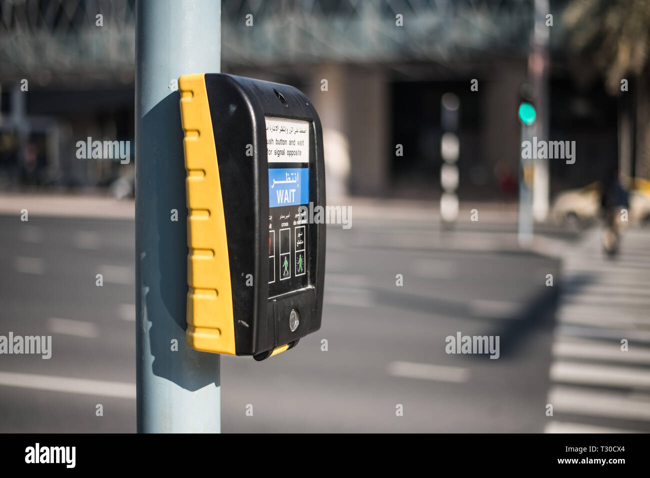 A device with a traffic light control button for pedestrians shows a ...