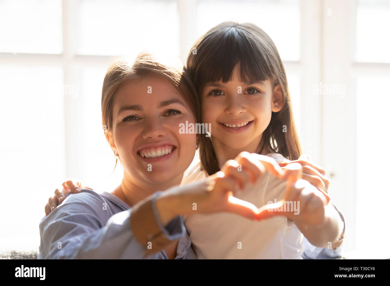 Headshot portrait mother and daughter make heart shape with hands Stock ...