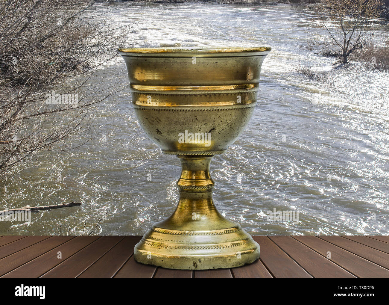 Old chalice on wooden table with water background Stock Photo - Alamy