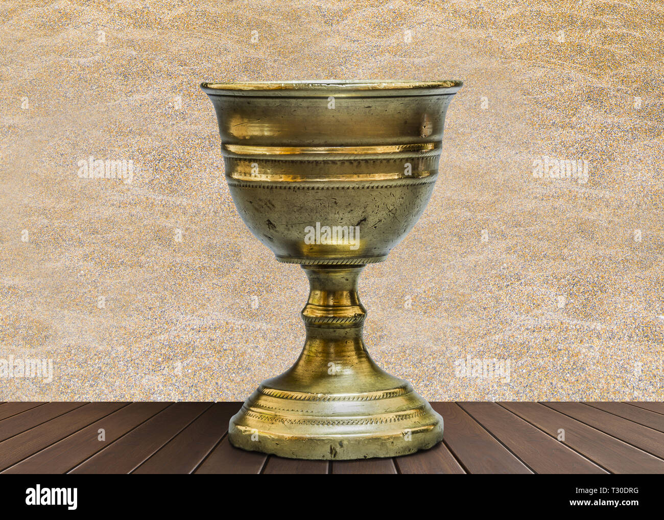 Old chalice on wooden table on sand background Stock Photo - Alamy