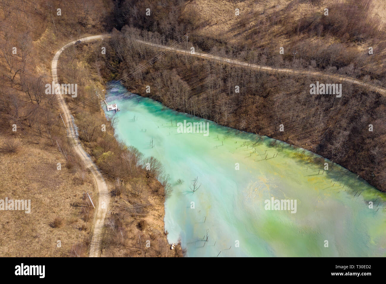 Aerial drone view of toxic chemical residuals flooding a lake from a ...