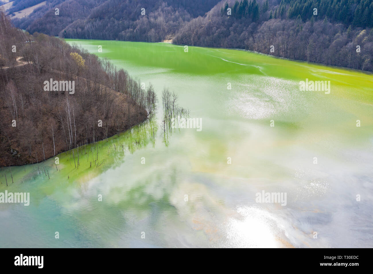 Aerial drone view of toxic chemical residuals flooding a lake from a ...
