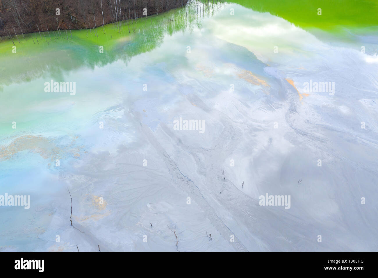 Aerial drone view of toxic chemical residuals flooding a lake from a ...