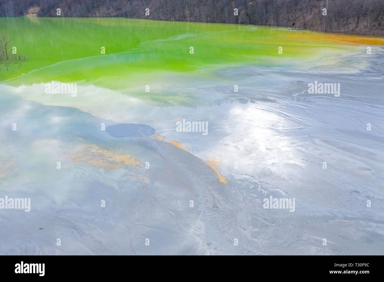 Aerial drone view of toxic chemical residuals flooding a lake from a ...