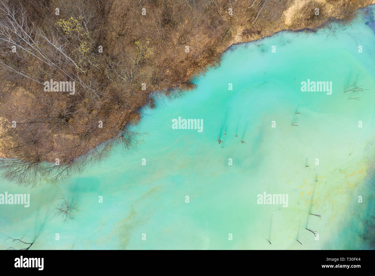 Aerial drone view of toxic chemical residuals flooding a lake from a ...