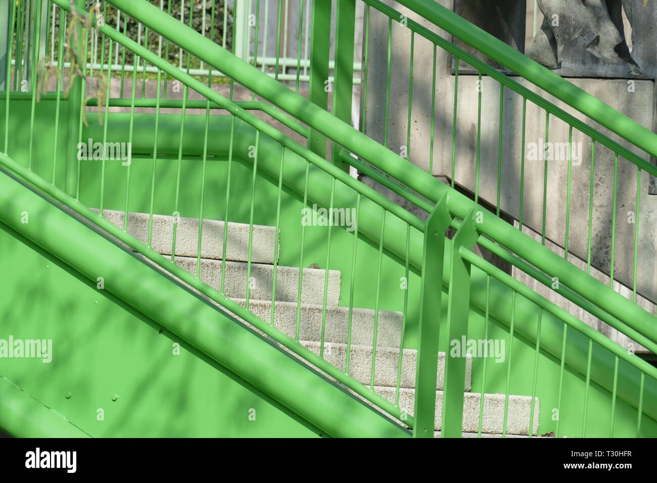 Concrete staircase and green stair railing Stock Photo - Alamy