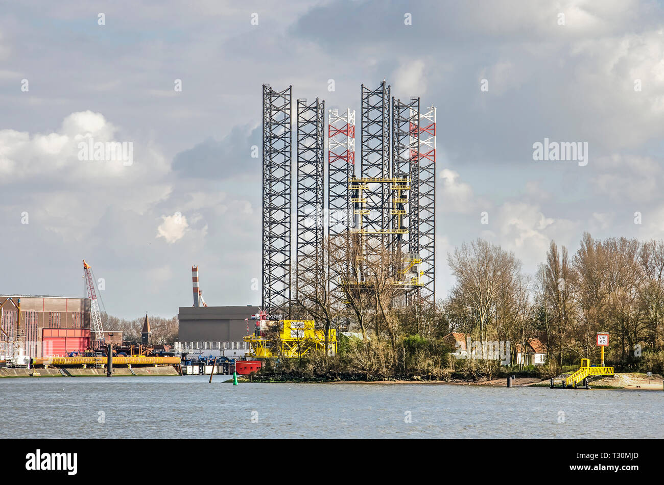 Rotterdam, The Netherlands, March 19, 2019: cranes, sheds and an oil ...