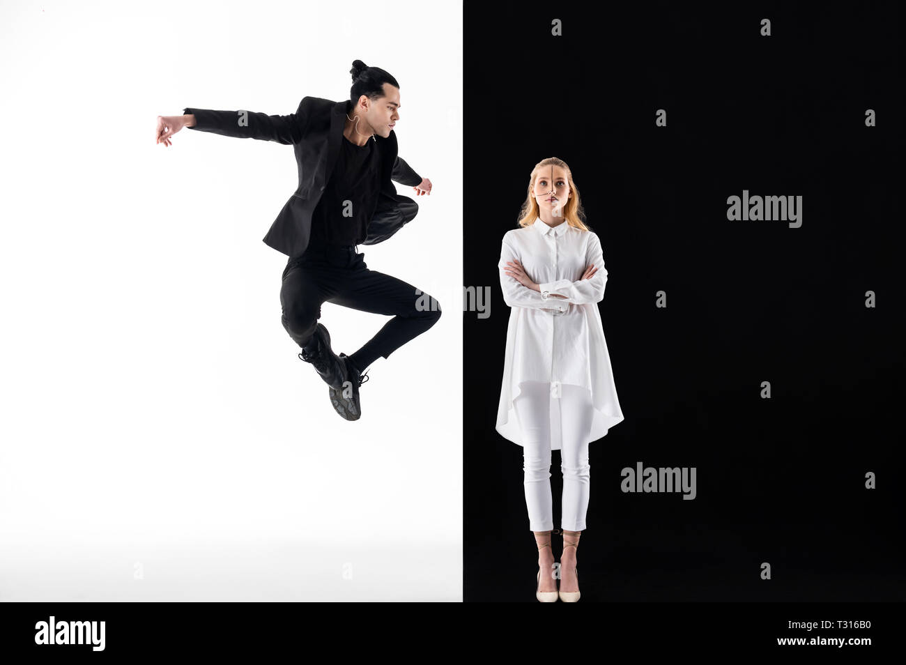 Man jumping. Dark-haired handsome man wearing black suit jumping posing ...