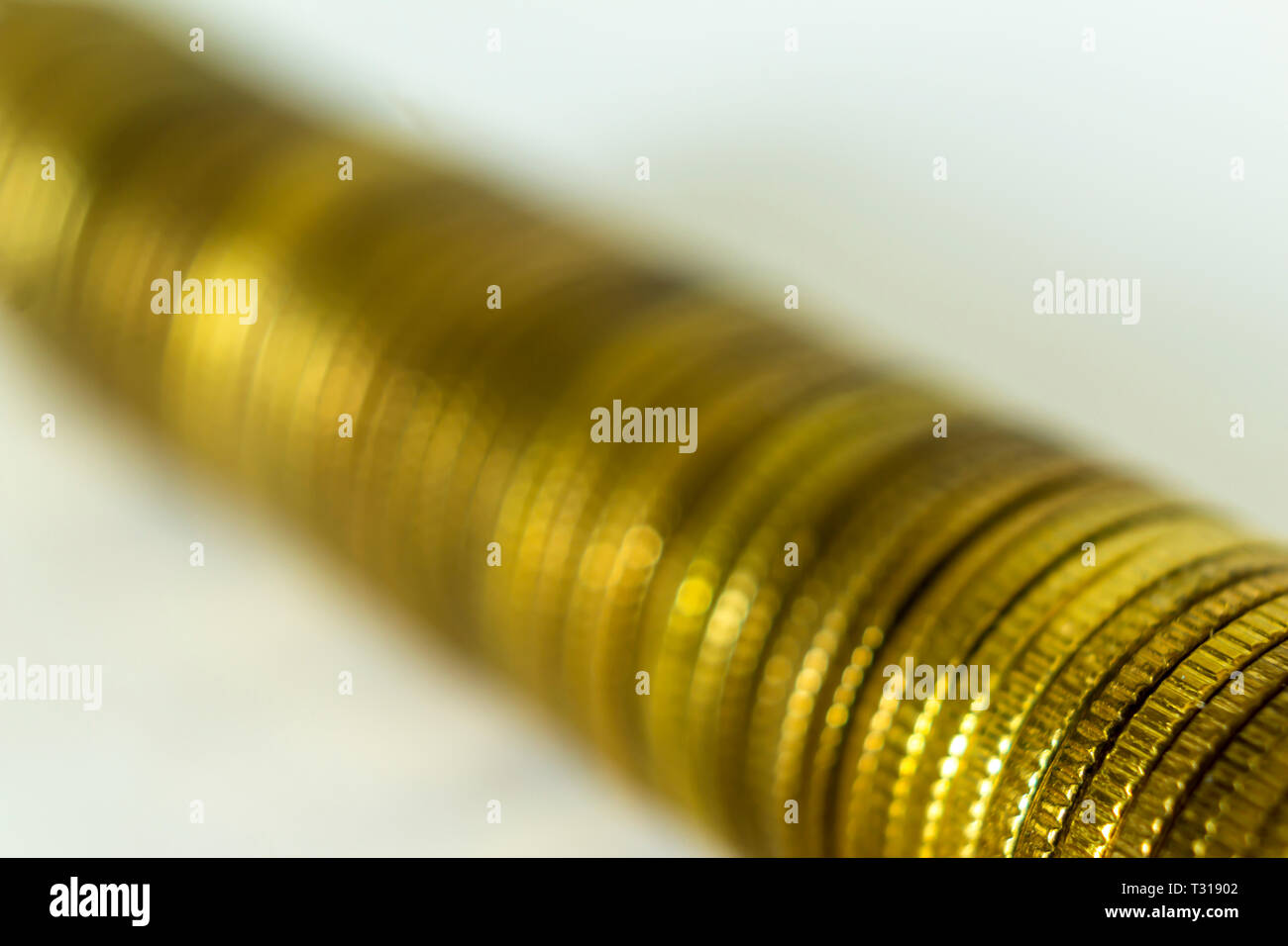 Macro photo of a long stack of coins. Stack lying on their side. A good ...