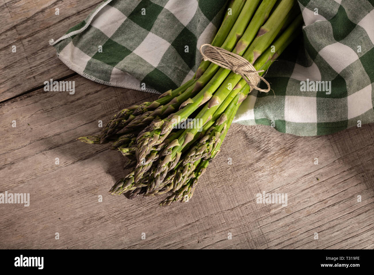 Fresh asparagus officinalis on wooden table. Rustic style Stock Photo ...