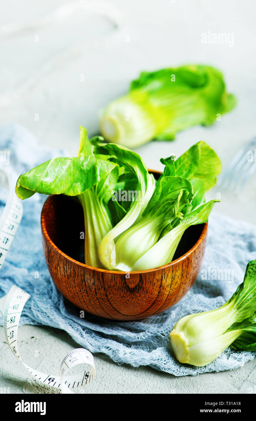 fresh pak choy in bowl and on a table Stock Photo - Alamy