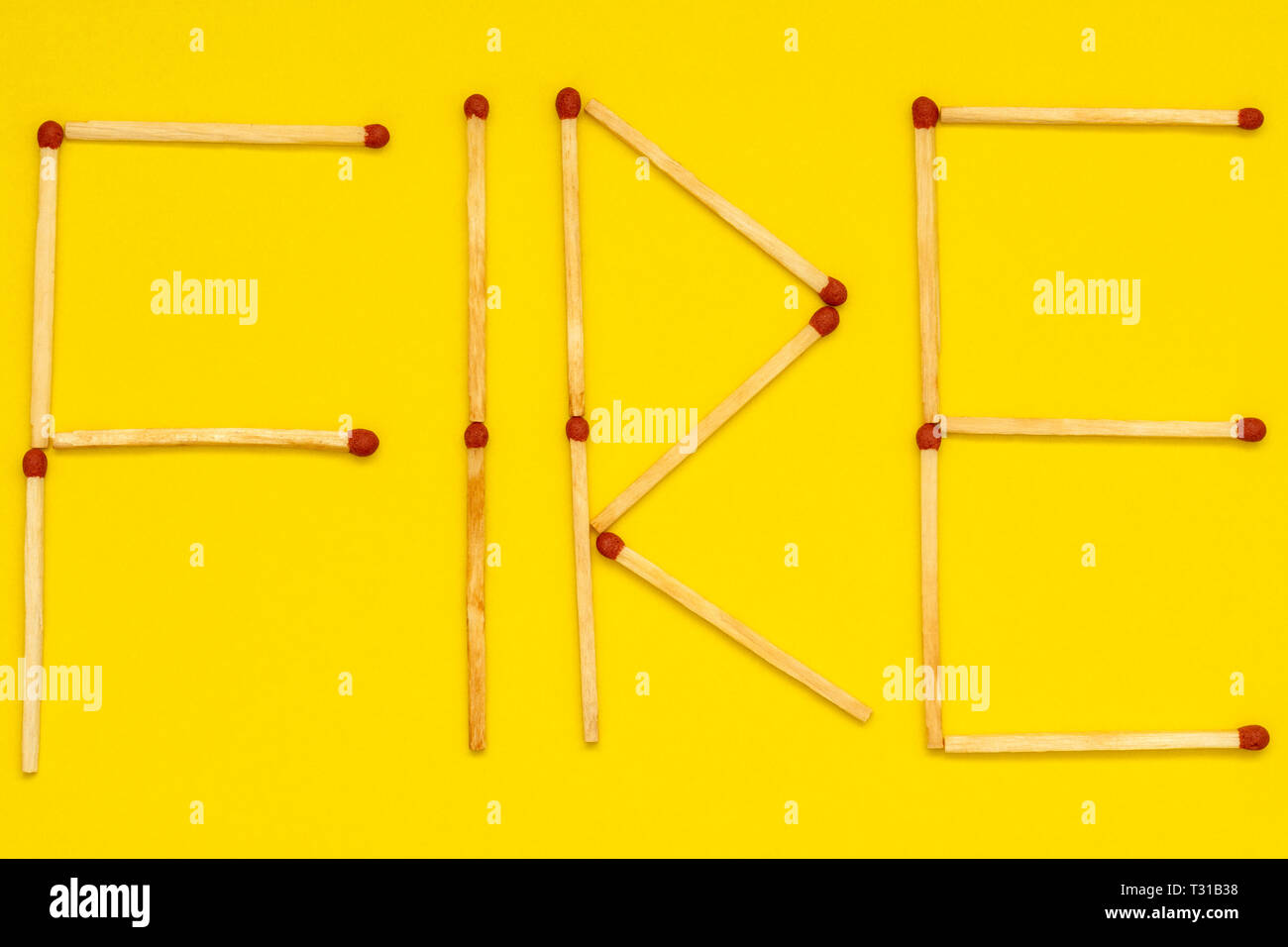 Word FIRE made with matches on yellow background Stock Photo - Alamy