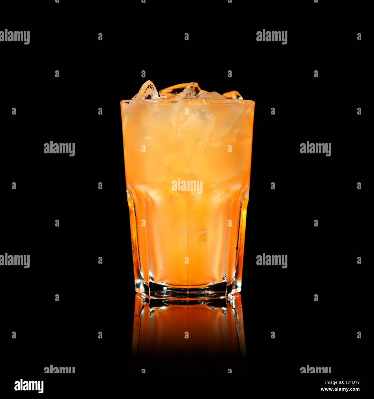 orange juice cocktail on a black background Stock Photo - Alamy