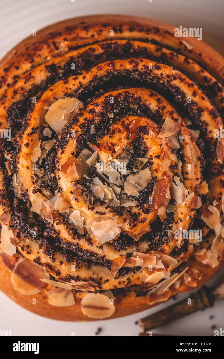 Vertical photo with top view on sweet rolled bun stuffed by poppy. Bun ...