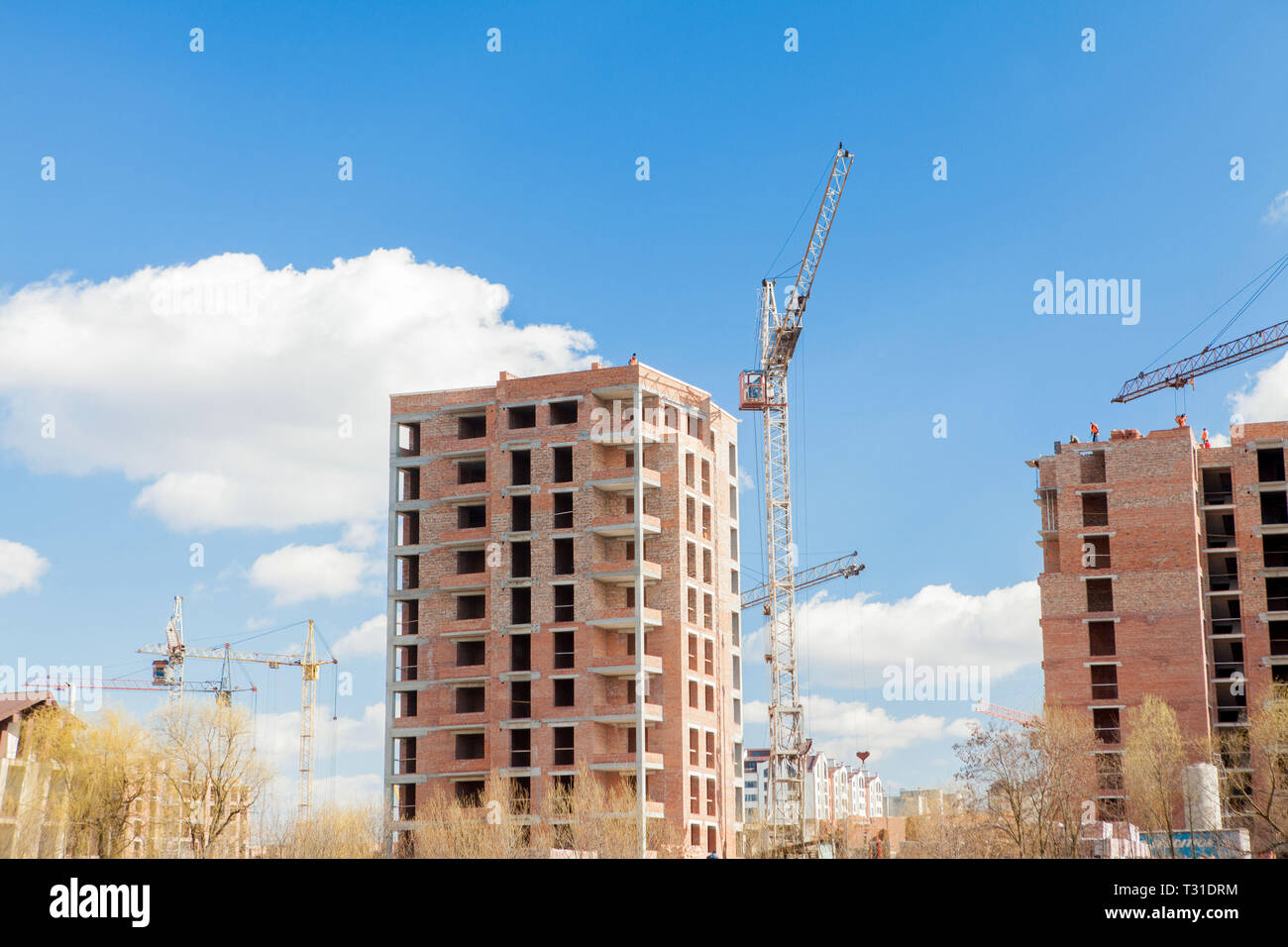 High-rise multi-storey buildings under construction. Tower cranes near ...