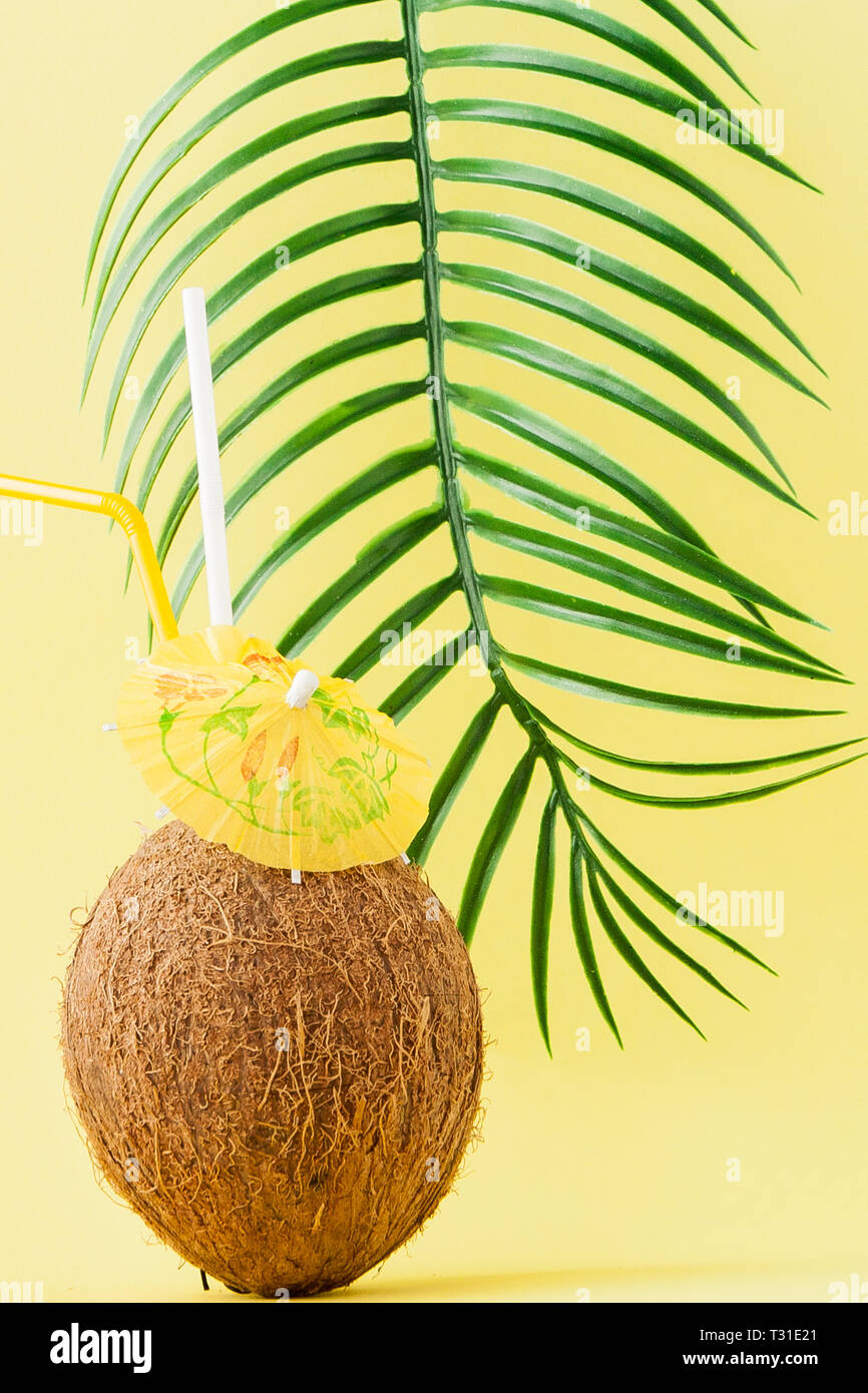 Fresh Coconut cocktail with a straws on yellow background Stock Photo ...