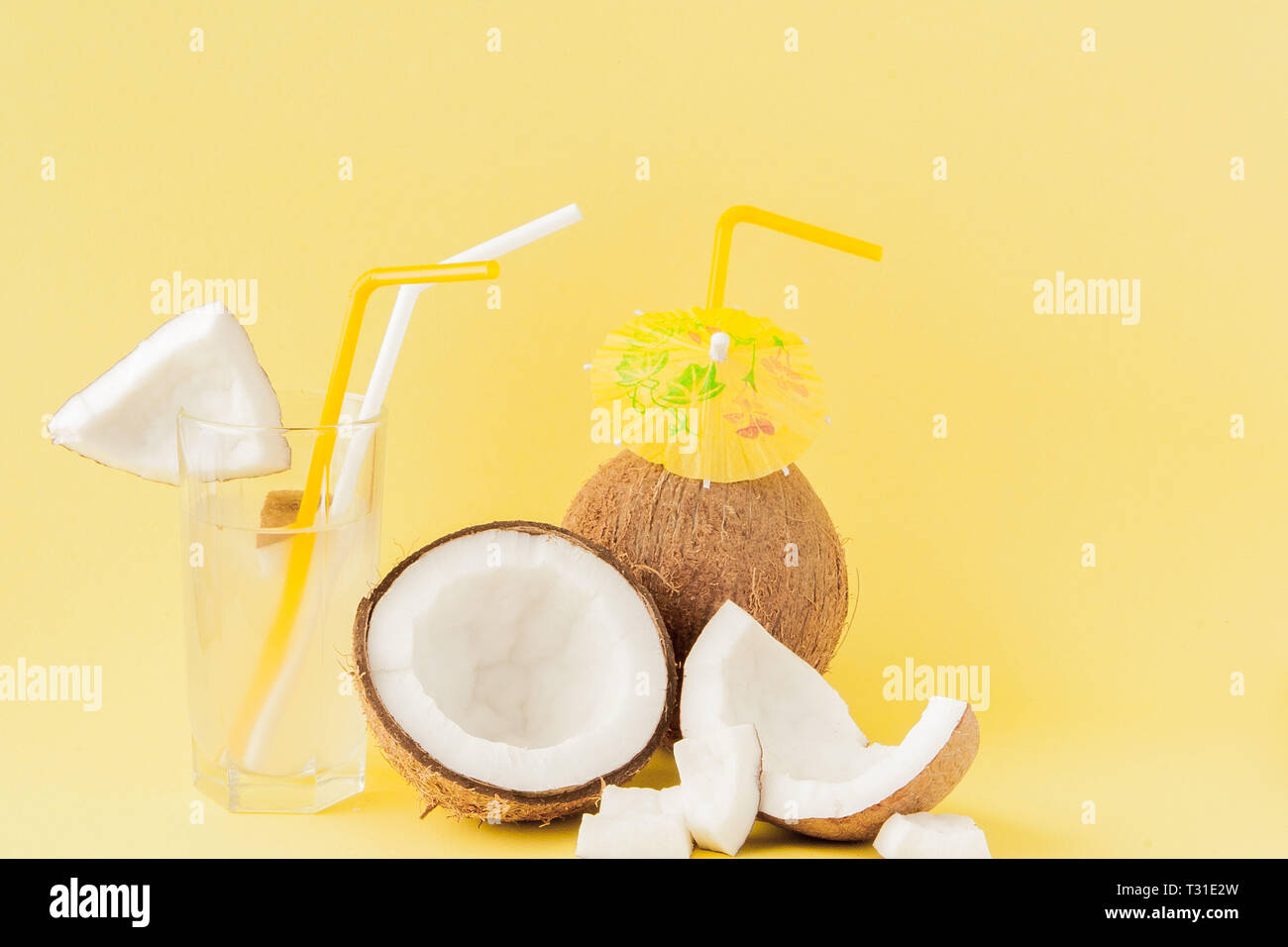 Fresh Coconut cocktail with a straws on yellow background Stock Photo ...