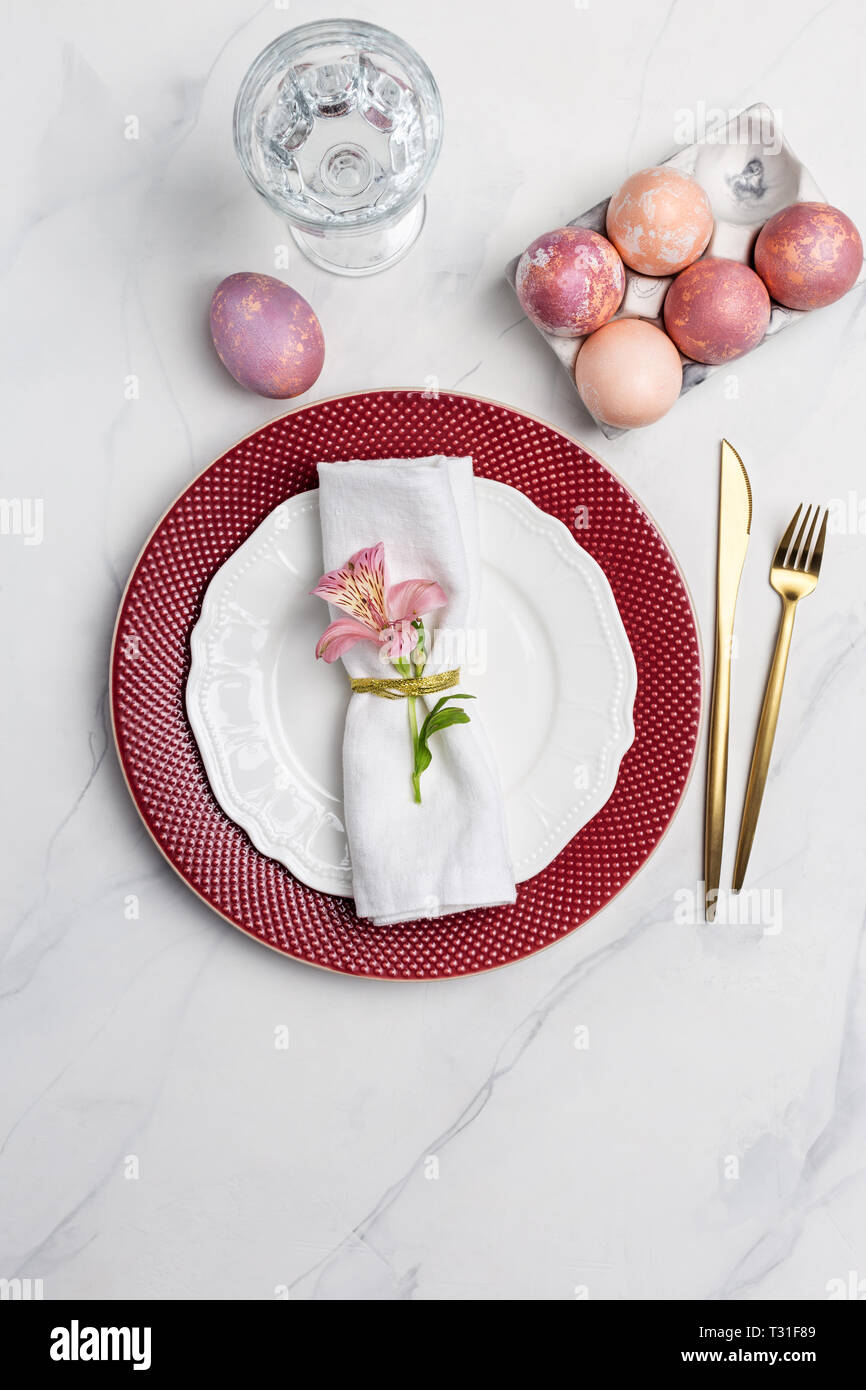 Serving plate for Easter breakfast with tableware and Easter eggs on ...