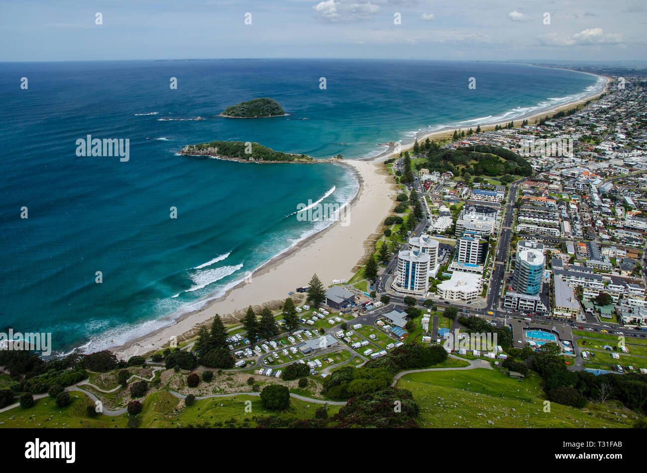 View of the coastline from the top of Mount Manganui with blue sky ...