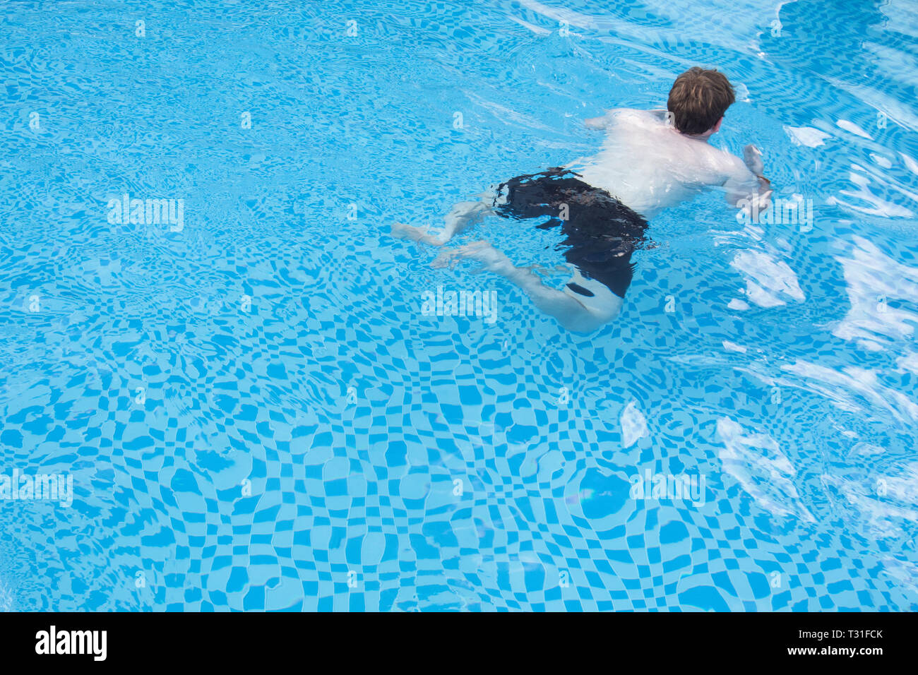 swimming pool ripples with a swimmer Stock Photo - Alamy