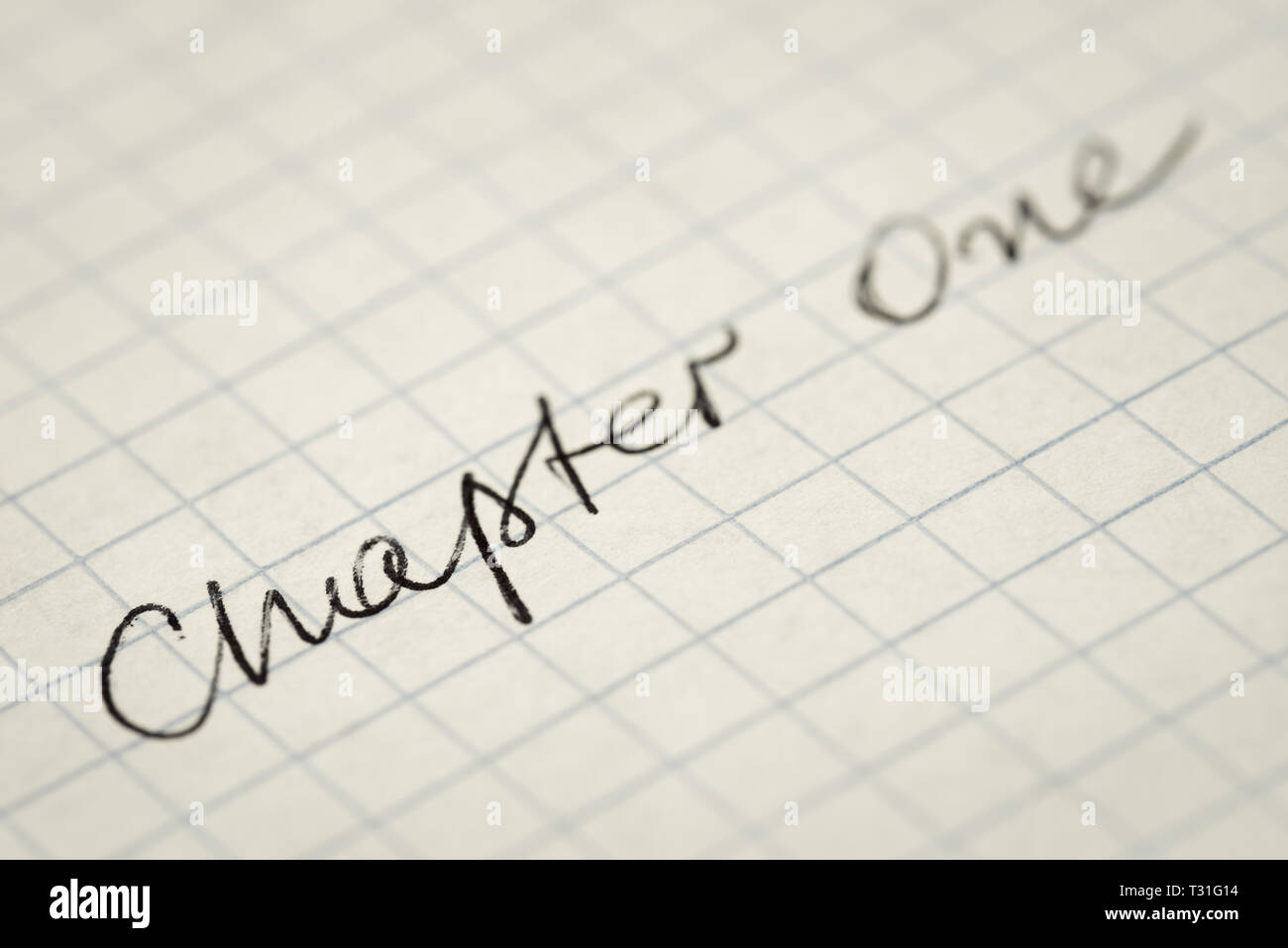 handwritten text Chapter One on old squared paper macro Stock Photo - Alamy