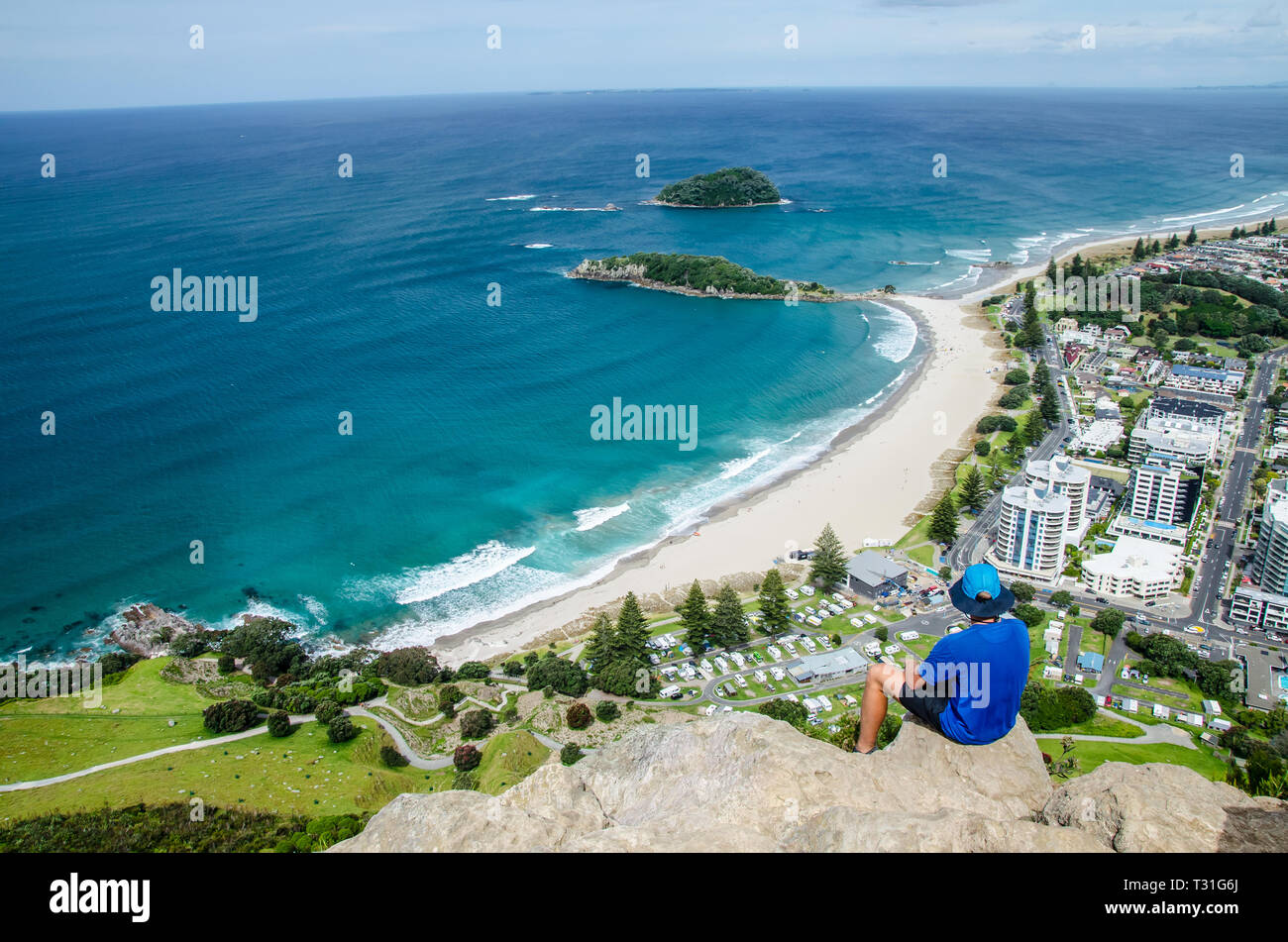 View of the coastline from the top of Mount Manganui with blue sky ...