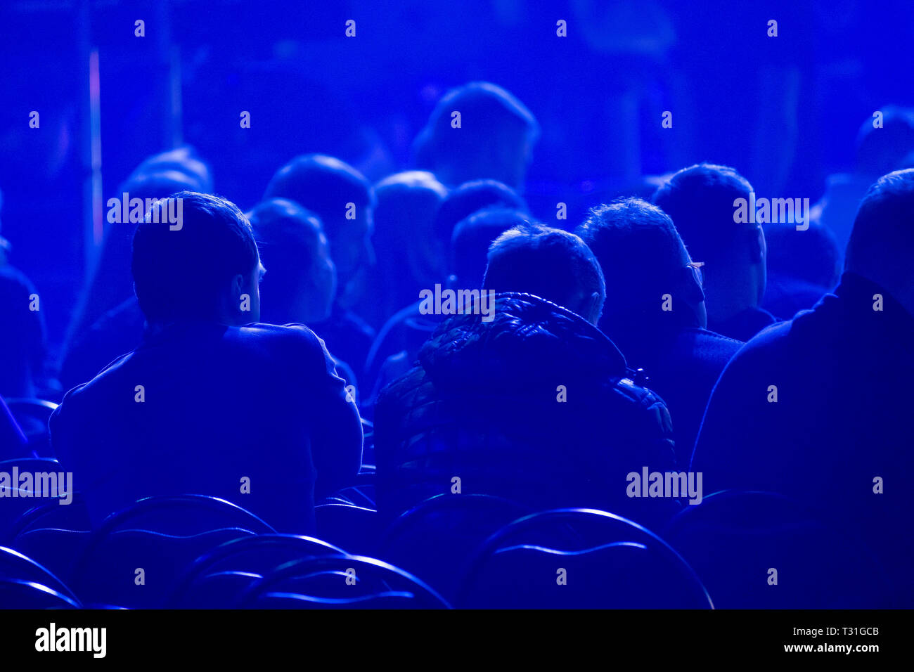Audience listens to the lecturer at the business conference, back view ...