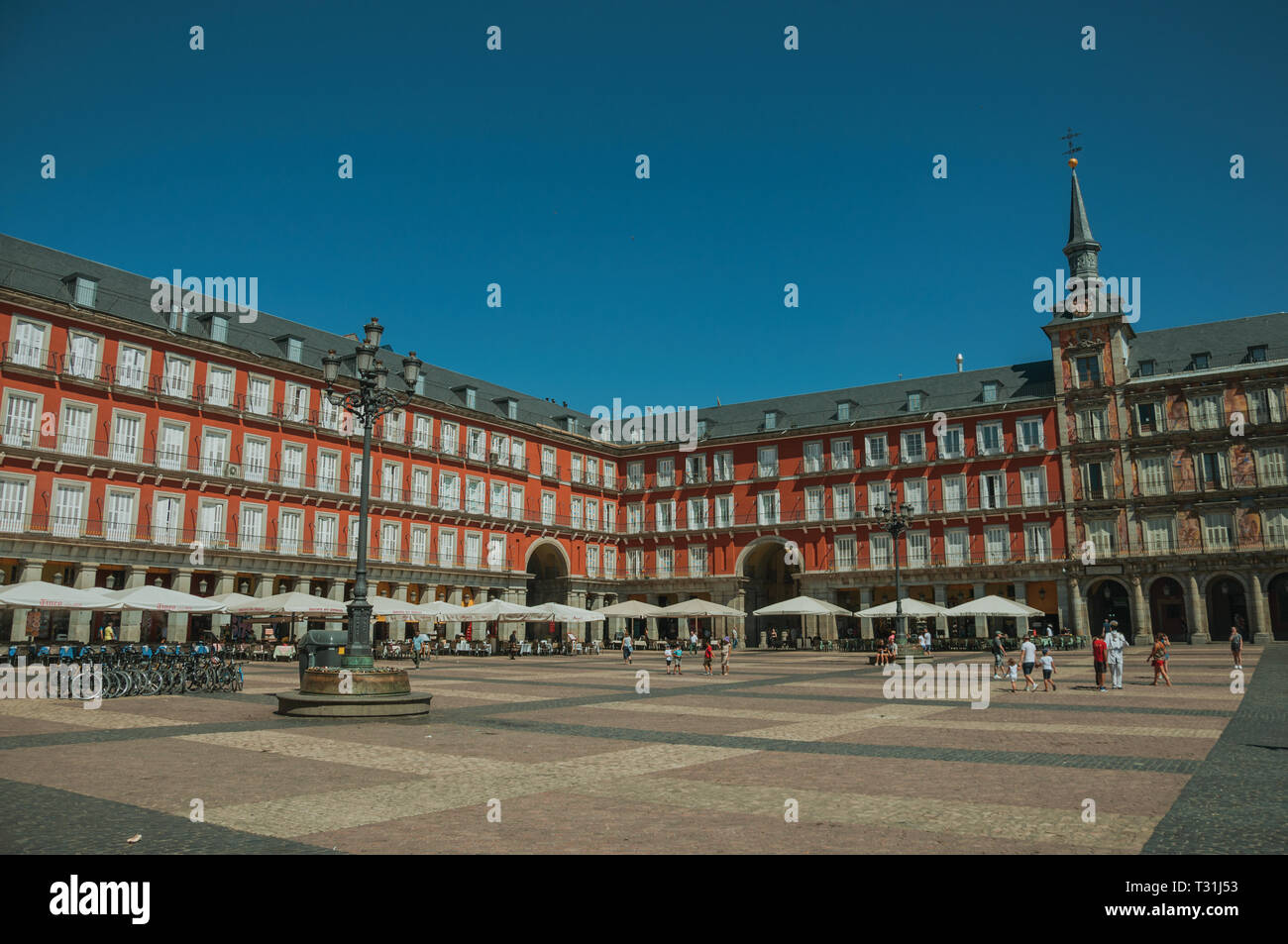 People on the Plaza Mayor encircled by old large building with ...