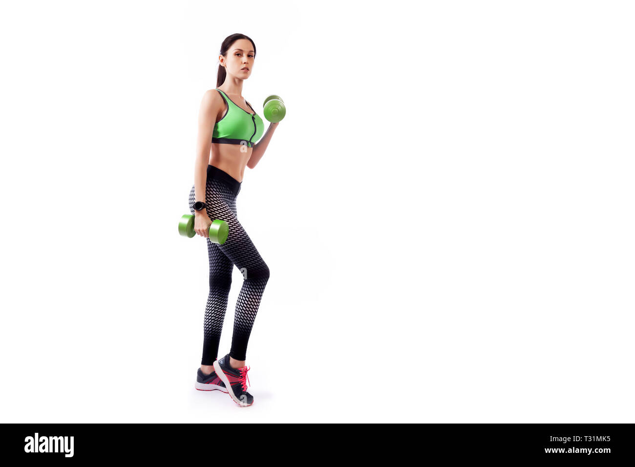 Young sportive woman fitness model brunette doing exercise with ...