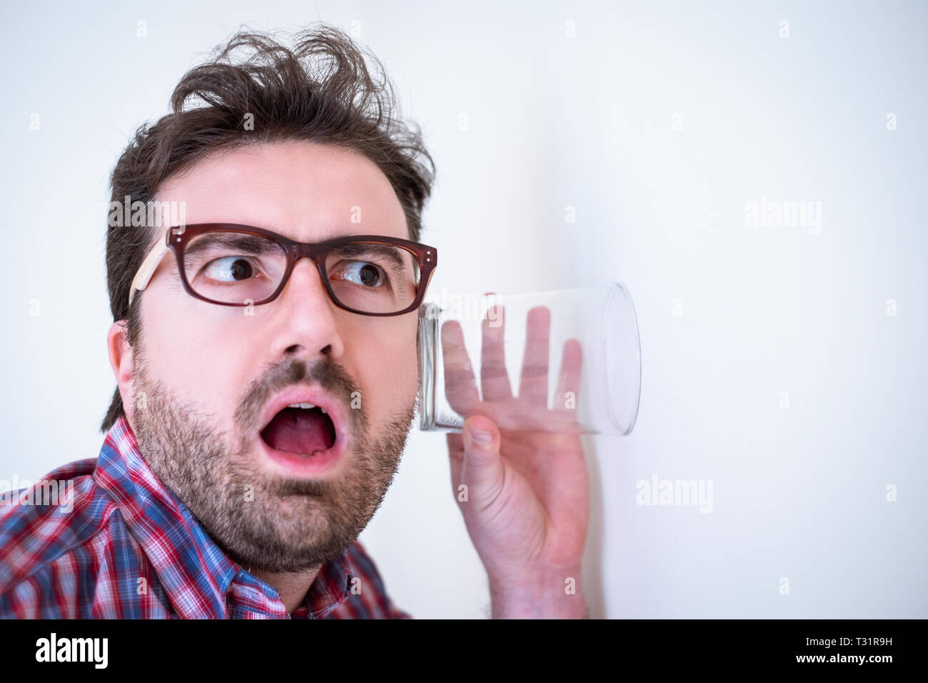 Spying glass to wall hi-res stock photography and images - Alamy
