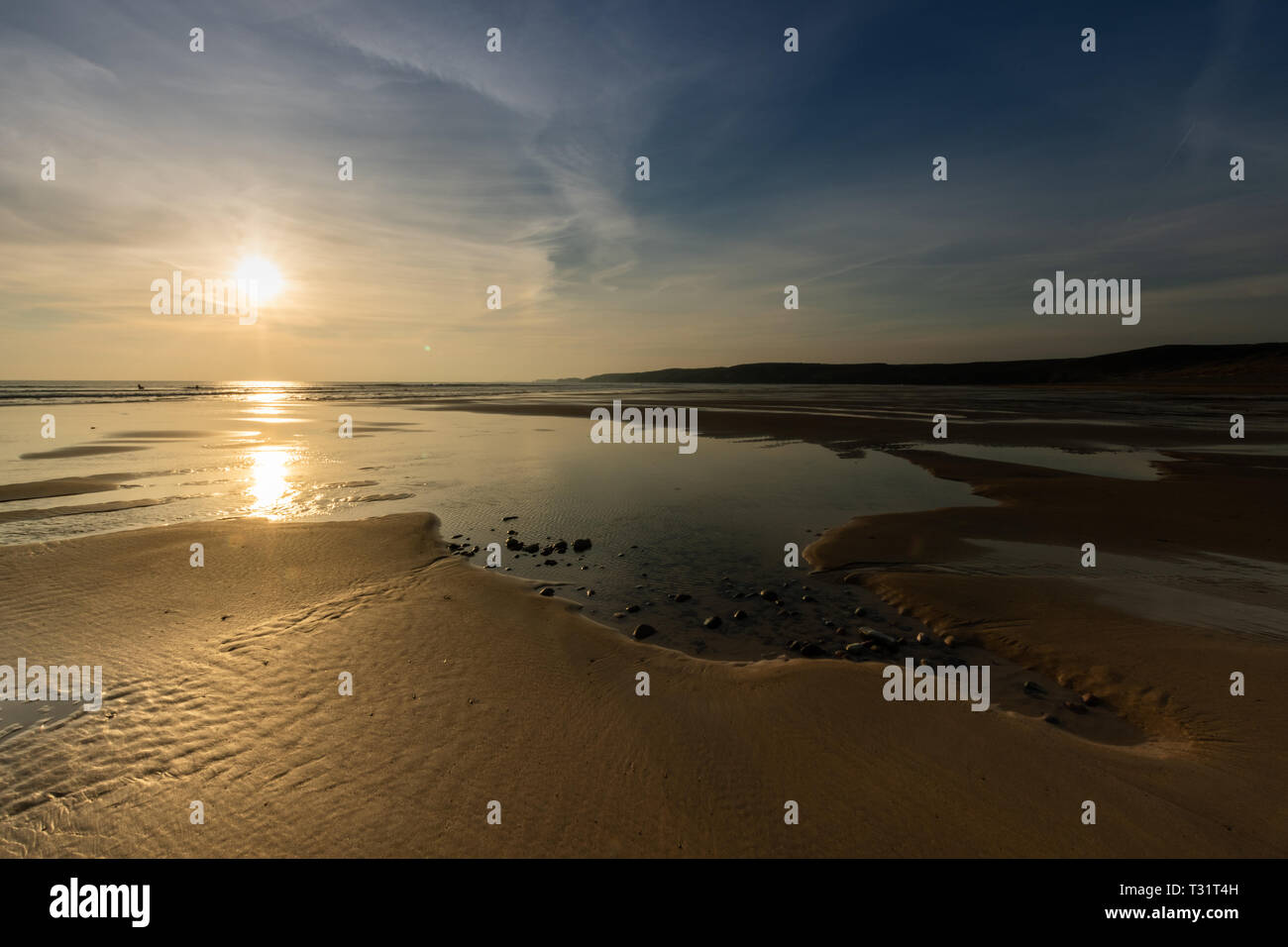 Angle Bay, Pembrokeshire, with pools of water as the sun goes down ...