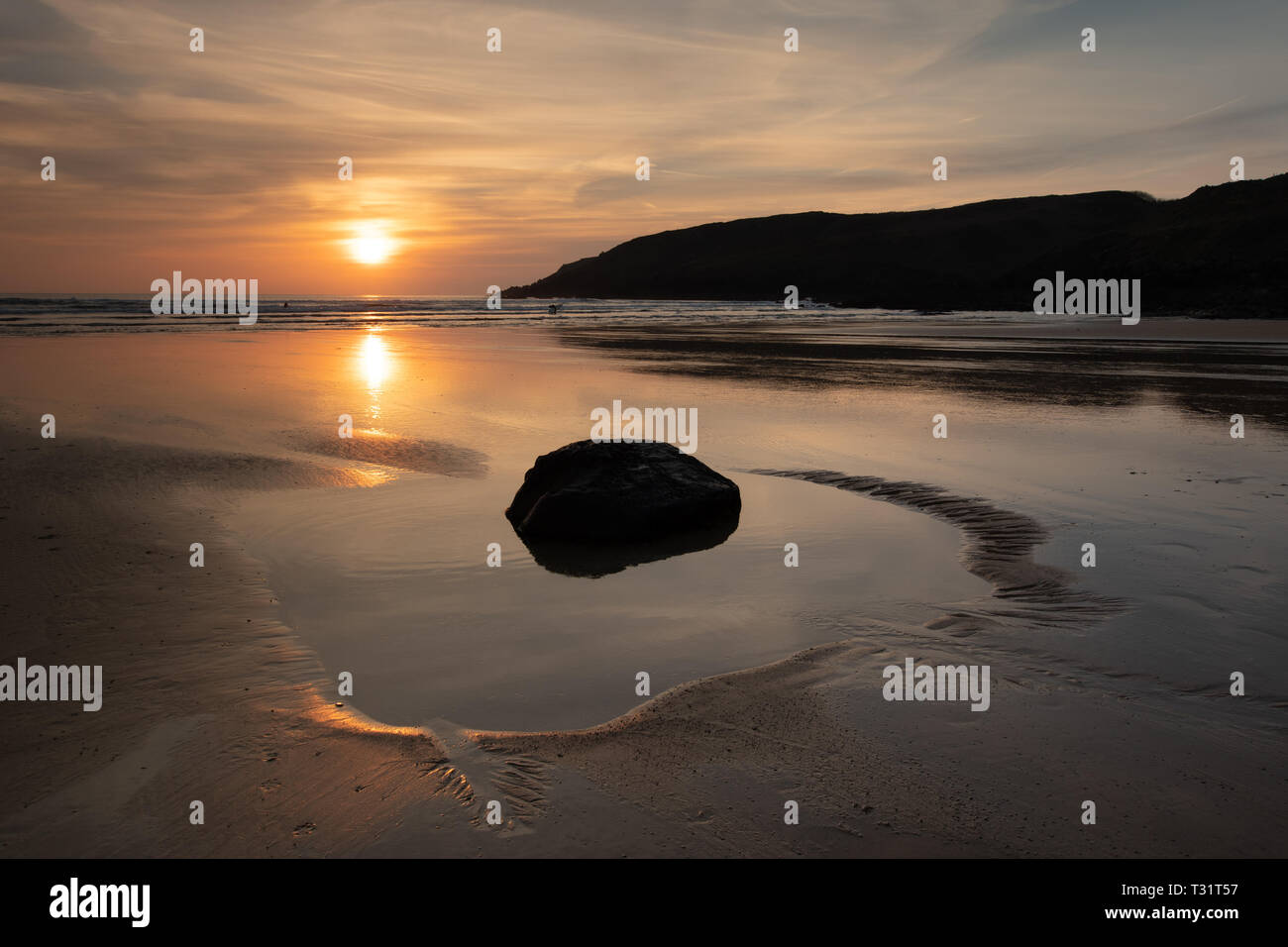 Angle Bay, Pembrokeshire, with pools of water as the sun goes down ...